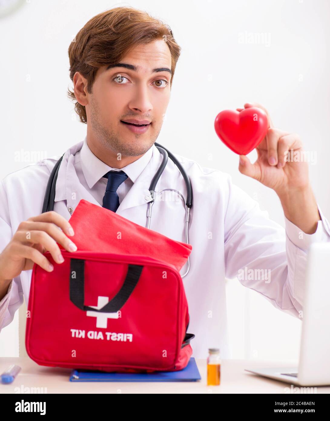 The young doctor with first aid kit in hospital Stock Photo - Alamy