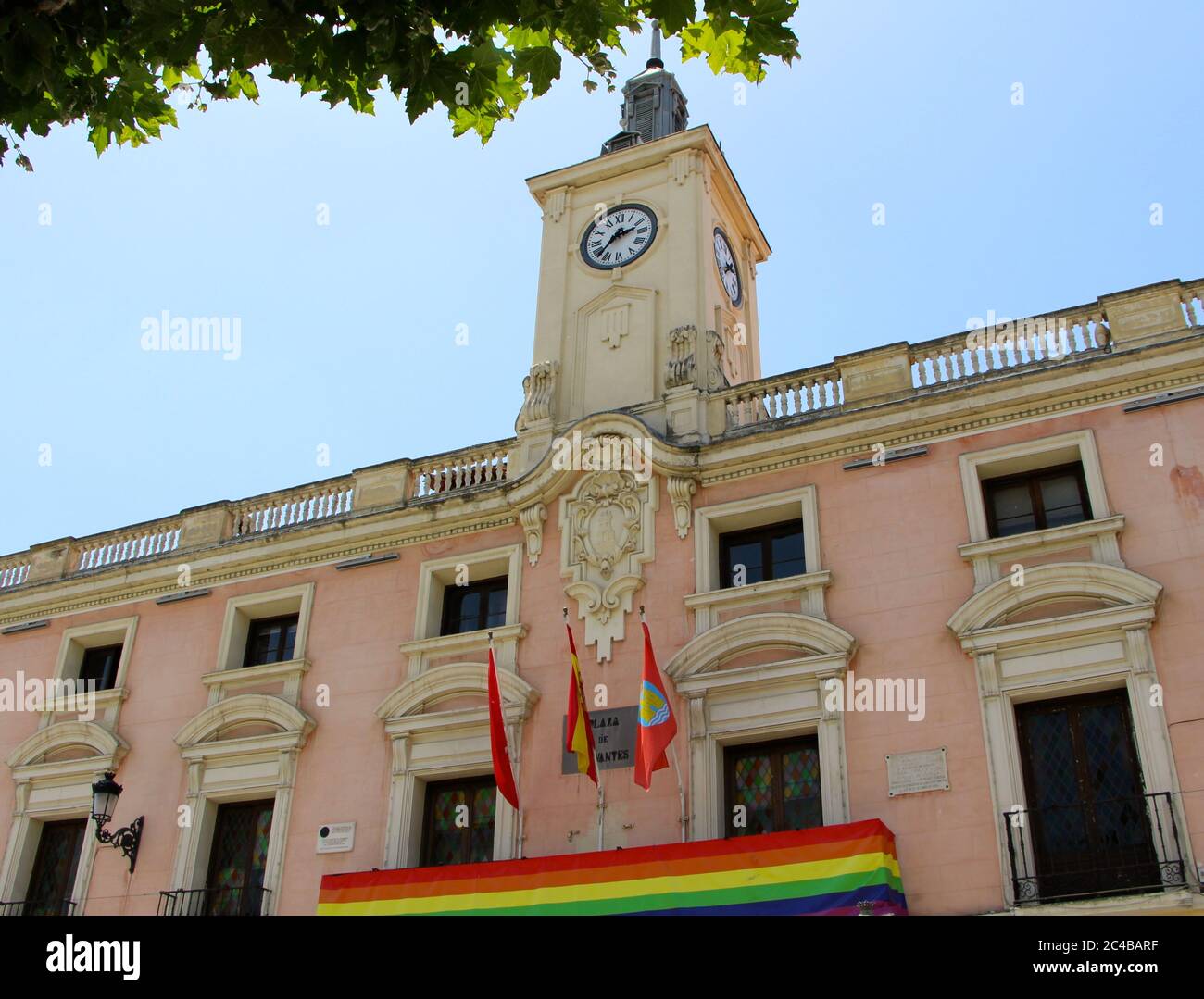 The town hall in Alcala de Henares with flags and a Gay Pride rainbow ...