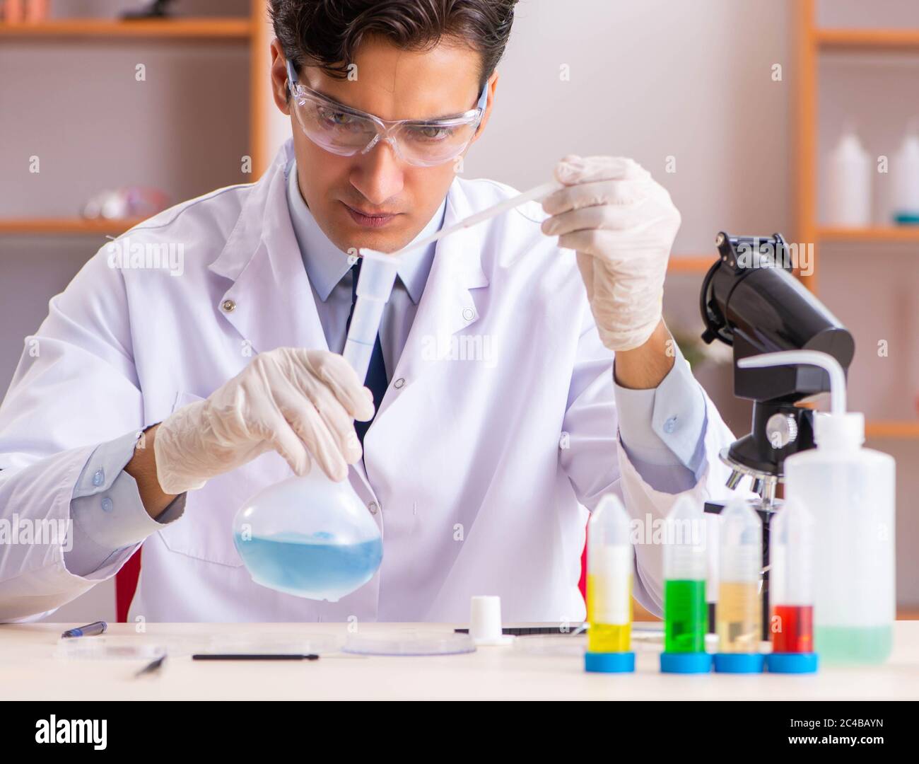 The young handsome biochemist working in the lab Stock Photo - Alamy