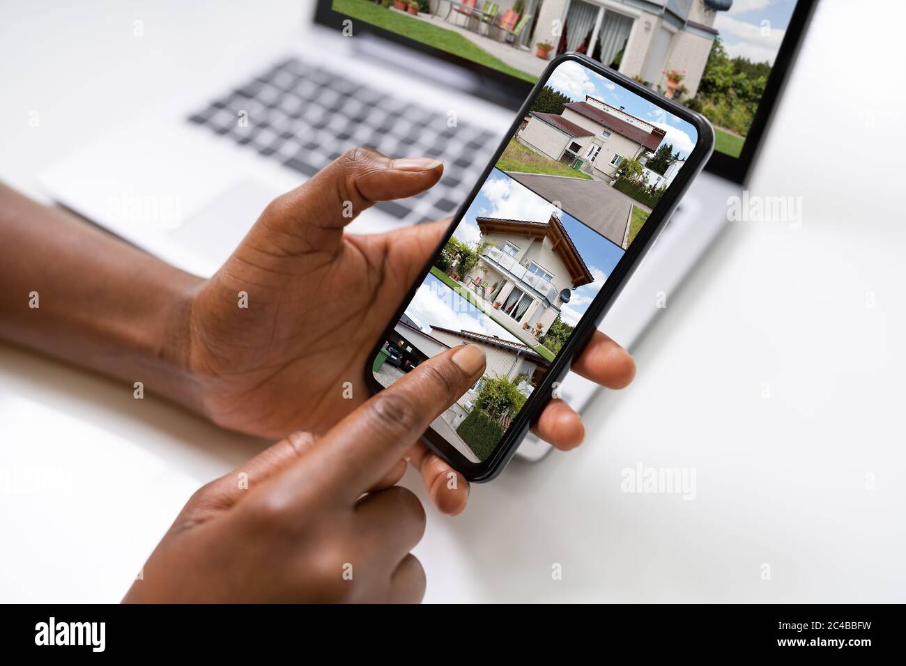 Mortgage Counseling Looking At House Photos On Mobile Phone Stock Photo ...