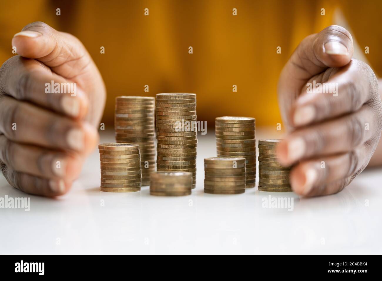 African Woman Protecting And Securing Money On Desk Stock Photo - Alamy