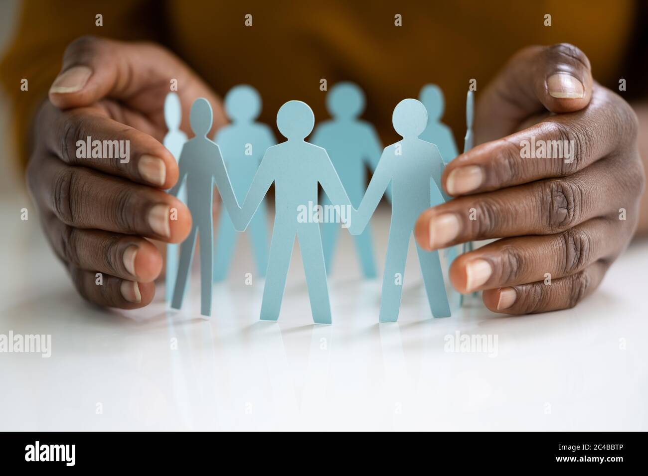 Employee Or Insurer Hand Protecting Employee Figures Stock Photo - Alamy