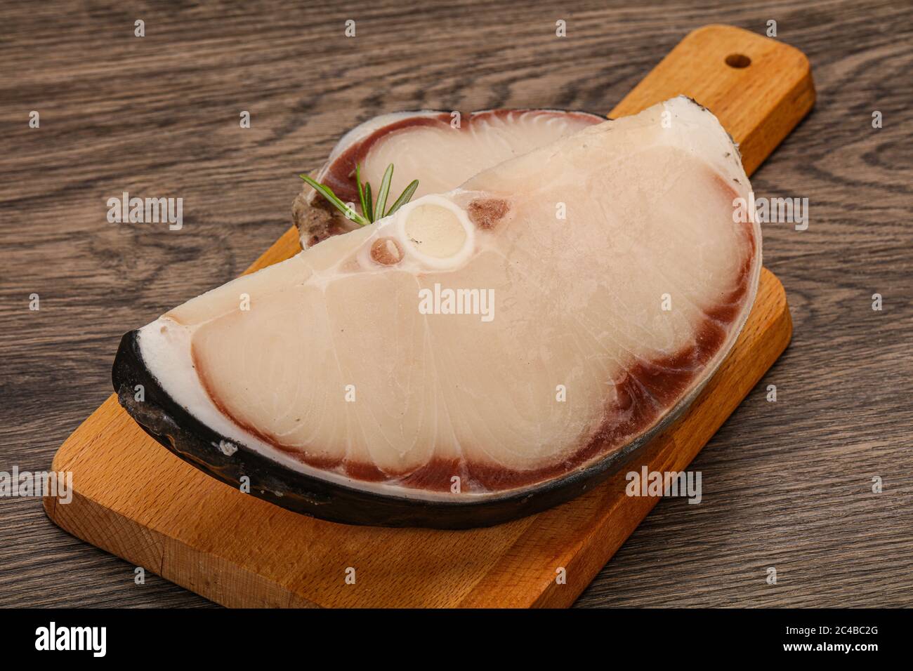 Raw shark steak served rosemary for cooking Stock Photo - Alamy