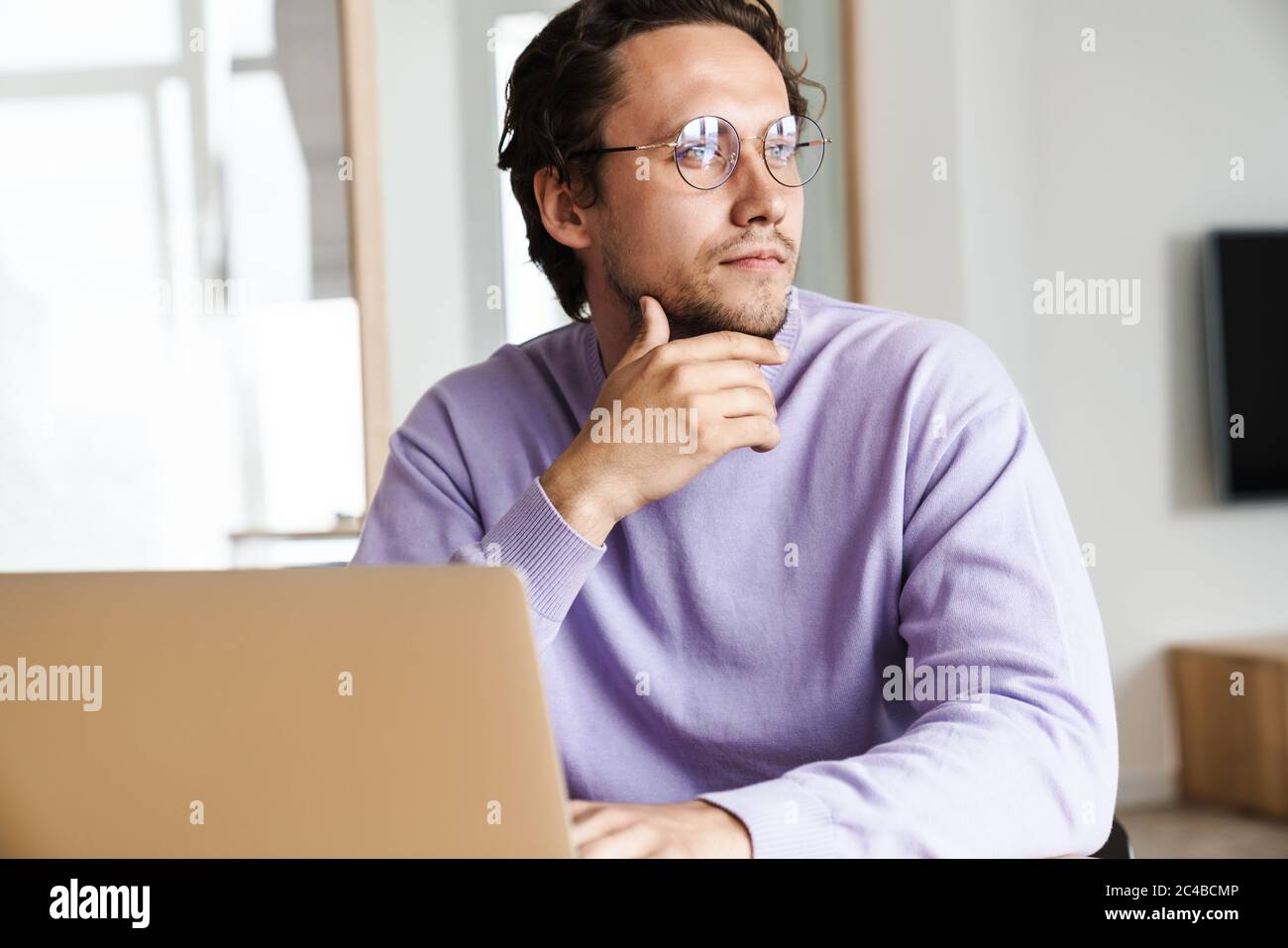 Charming young man sitting table hi-res stock photography and images ...