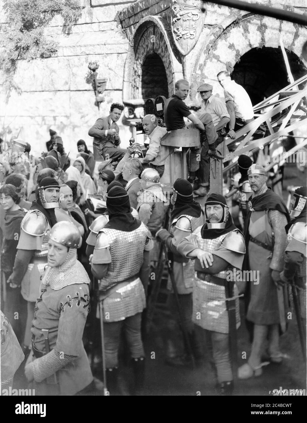Director CECIL B. DeMILLE on camera crane filming extras in THE ...