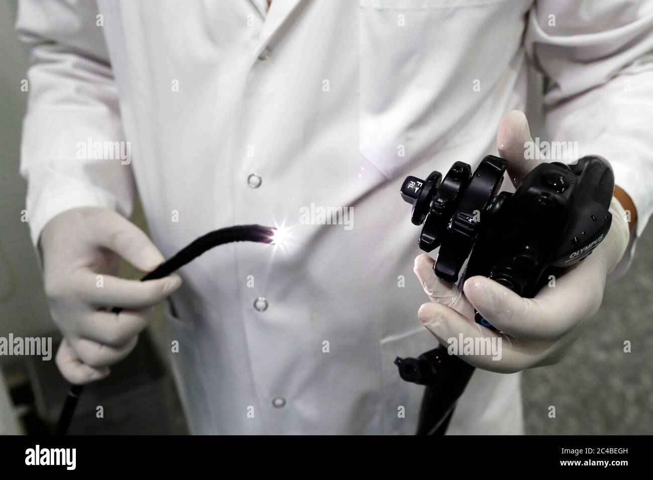 Doctor testing lighted probe used for endoscopy testing Stock Photo - Alamy