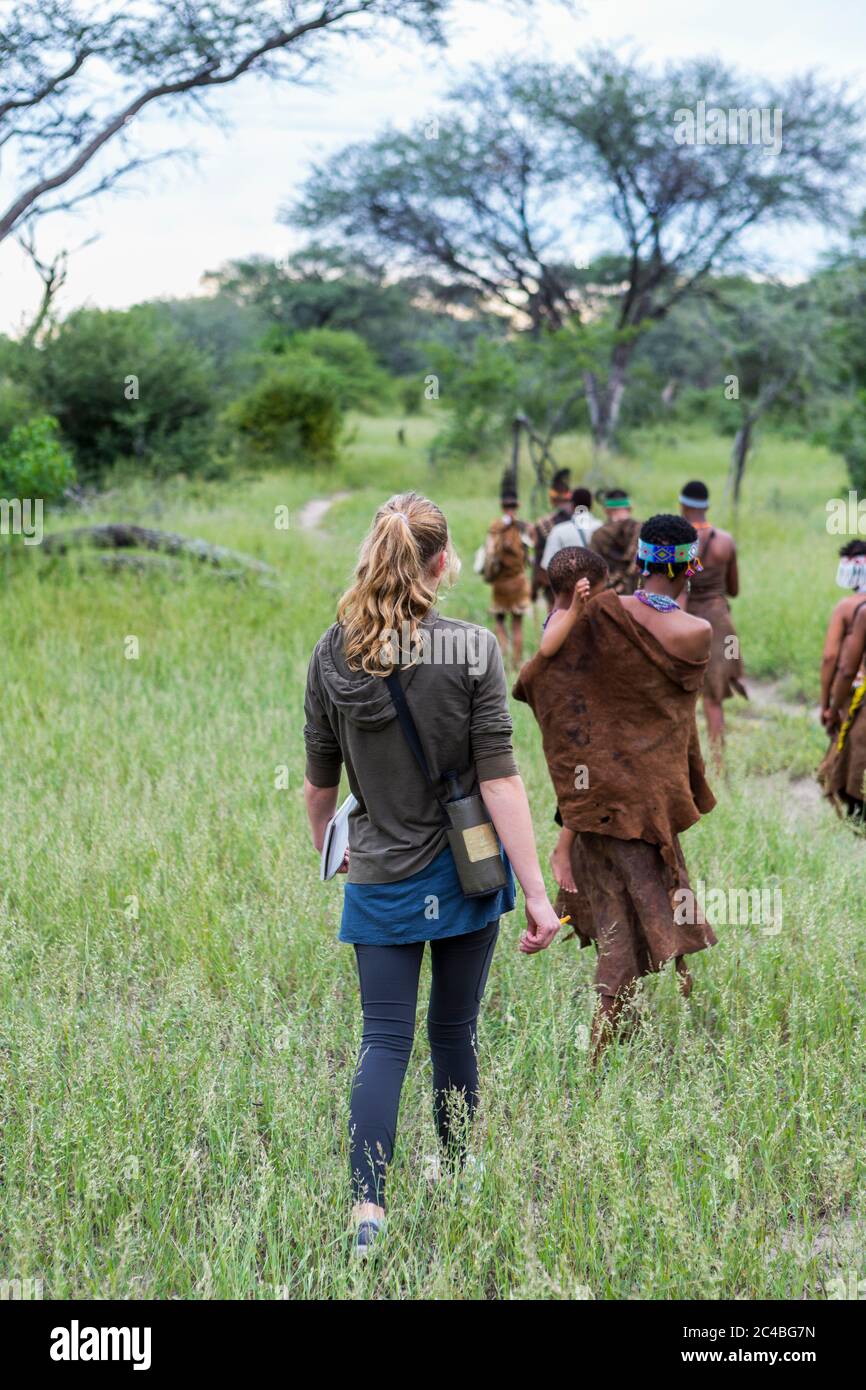 Tourists on a walking trail with members of the San people, bushmen ...