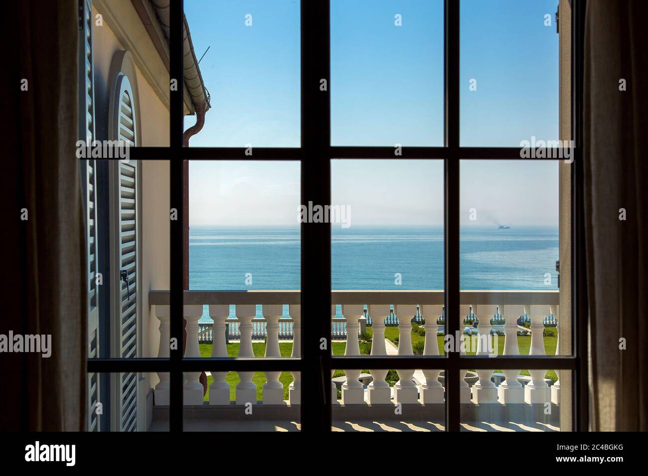 view from the window inside the room on the balcony with balustrades ...
