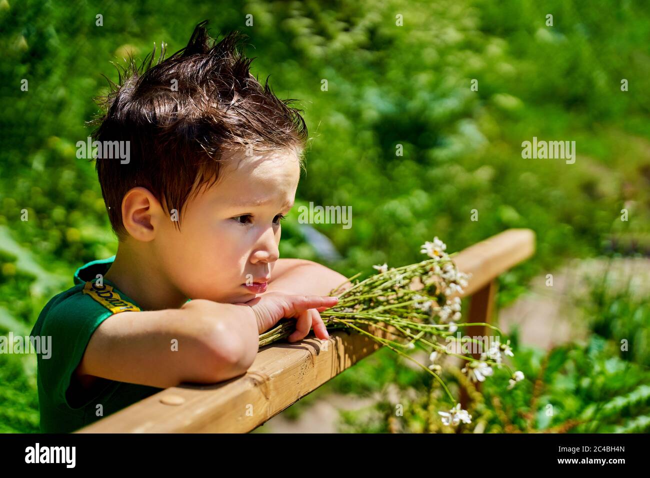 Portrait of sad little boy standing on the bridge at the day time Stock ...