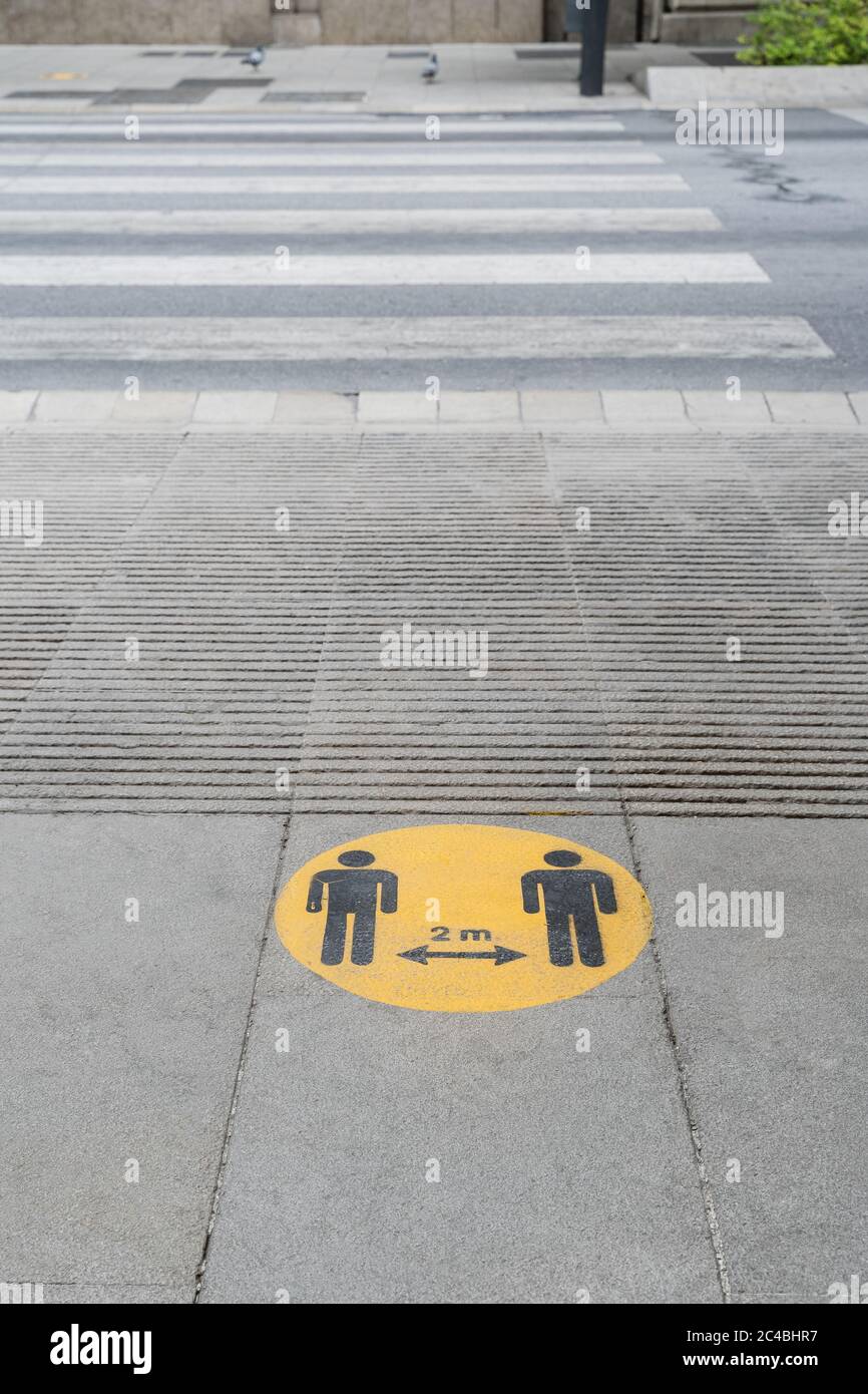 a two meters social distance sign drawn on the ground during the ...