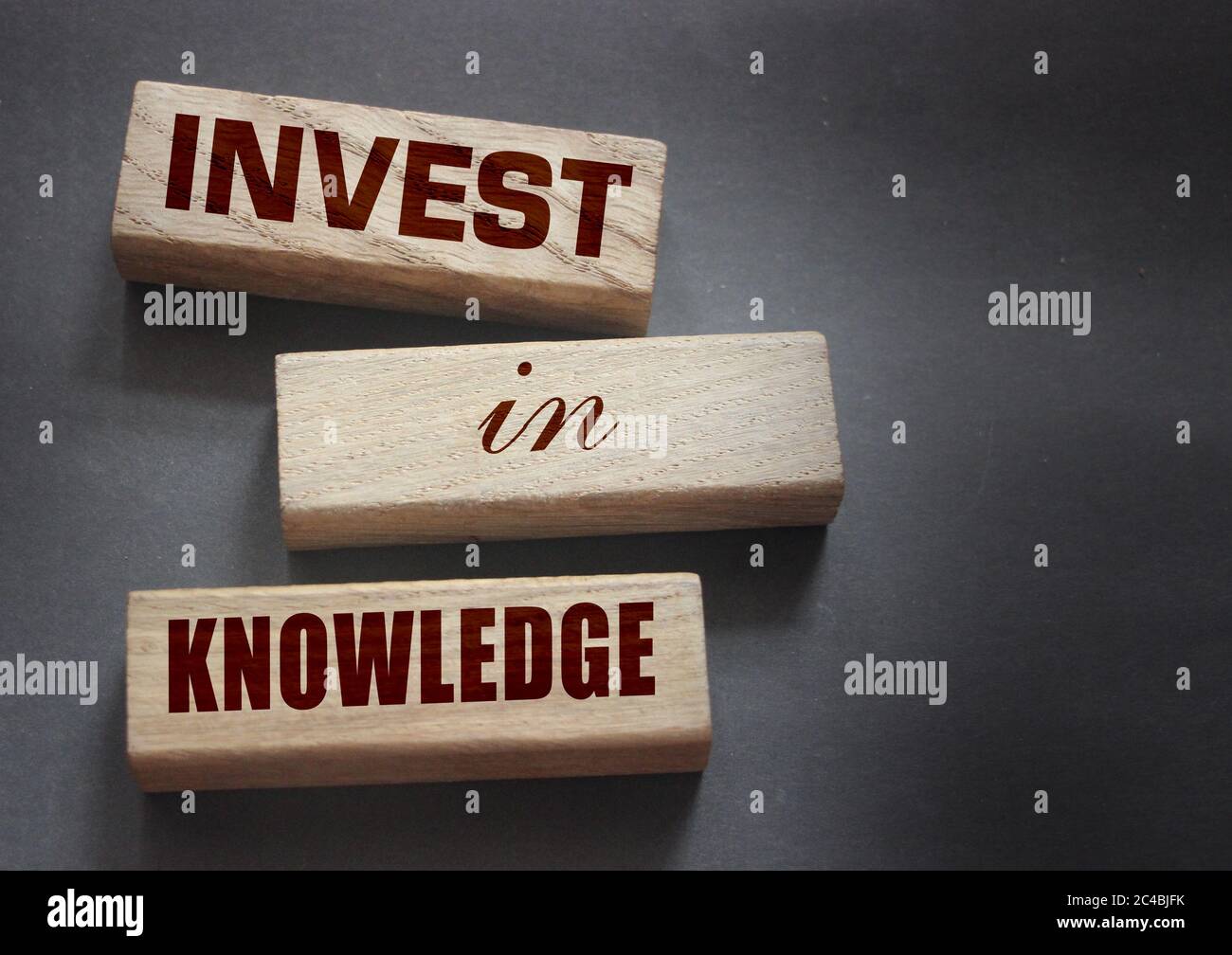 Invest in knowledge words onwooden blocks. Inspirational motivational ...