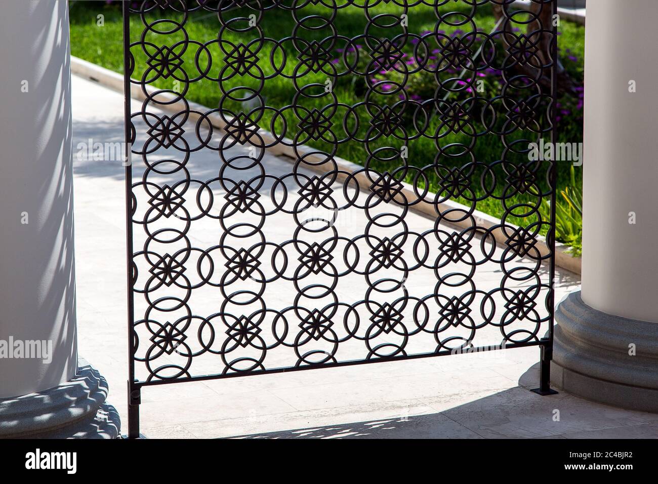 iron forged fence with a traditional Italian pattern among the stone ...