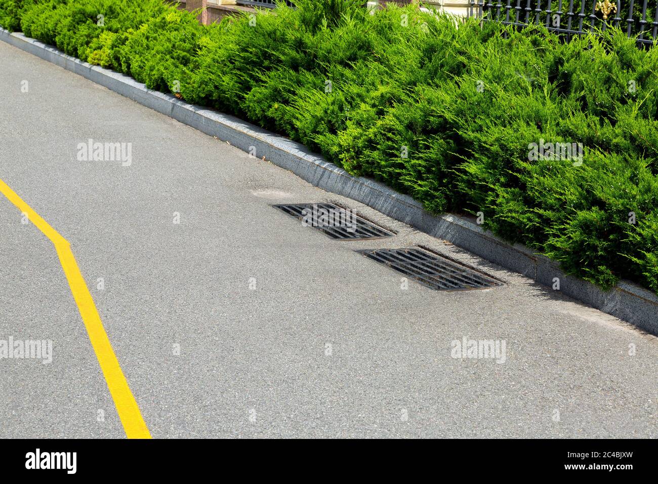 highway with asphalt pavement and yellow markings, road with drainage ...