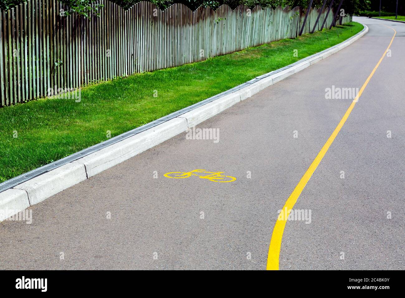 asphalt road with a lane for bicycles with a bicycle symbol and a ...
