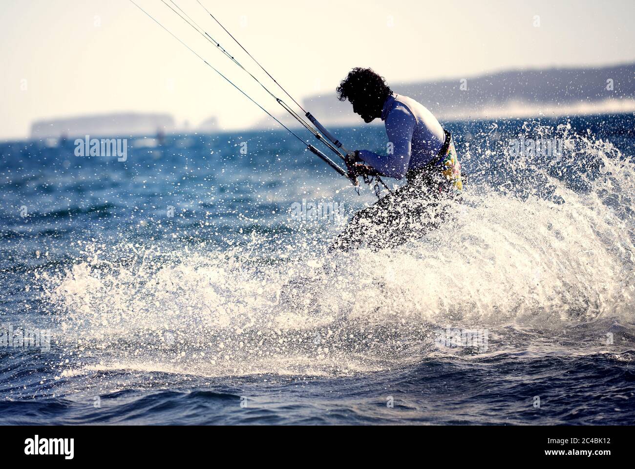 Side view of man kitesurfing on the ocean Stock Photo - Alamy