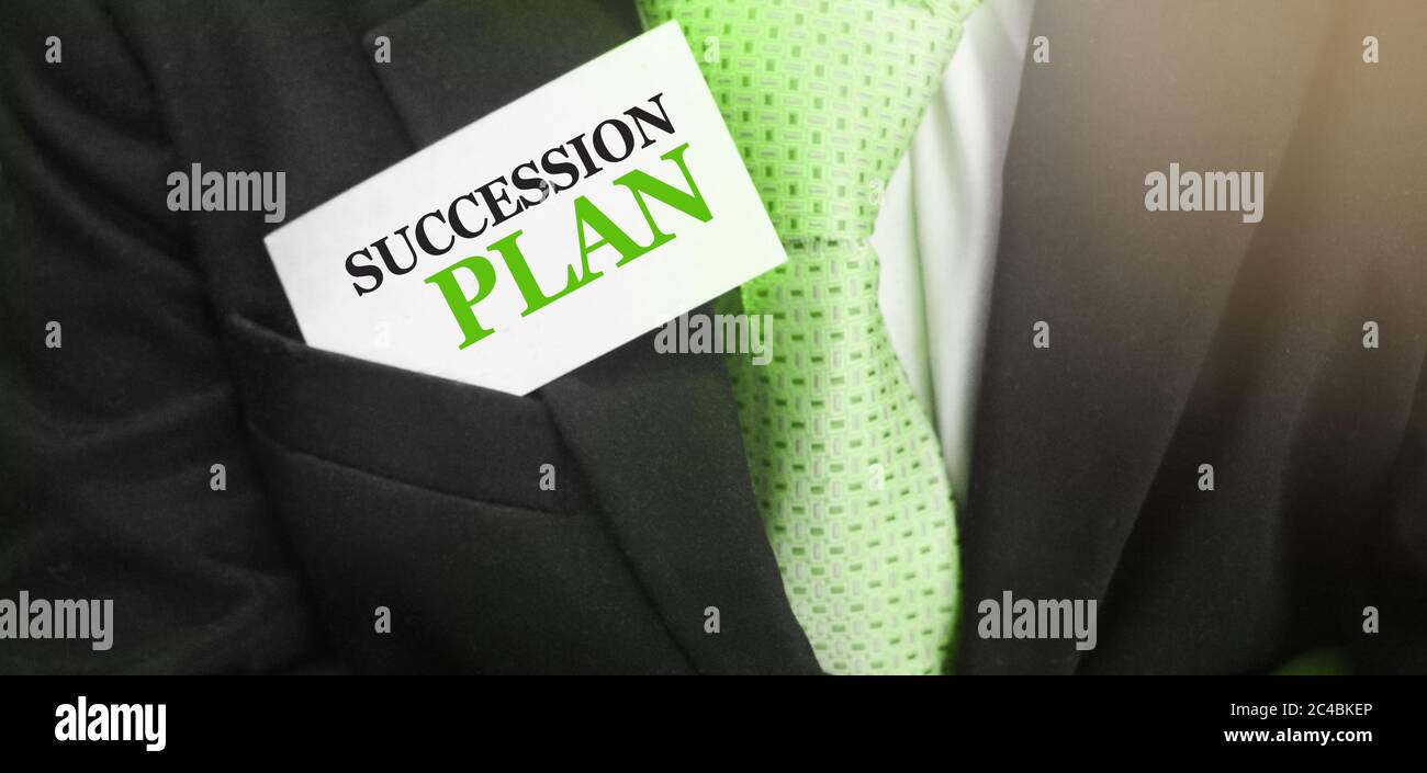 Succession Plan words on a card in upper pocket of businessman wearing ...