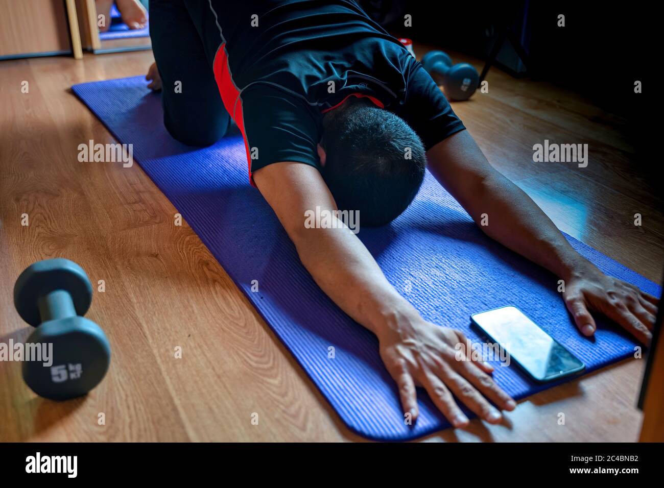 A man workout and does yoga at home during quarantine period due to ...