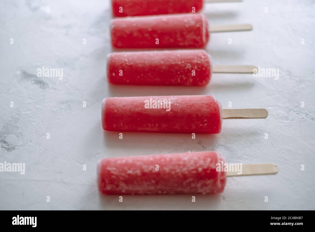 Pink fruit ice sorbet on a white background. Stick ice cream. Close up ...