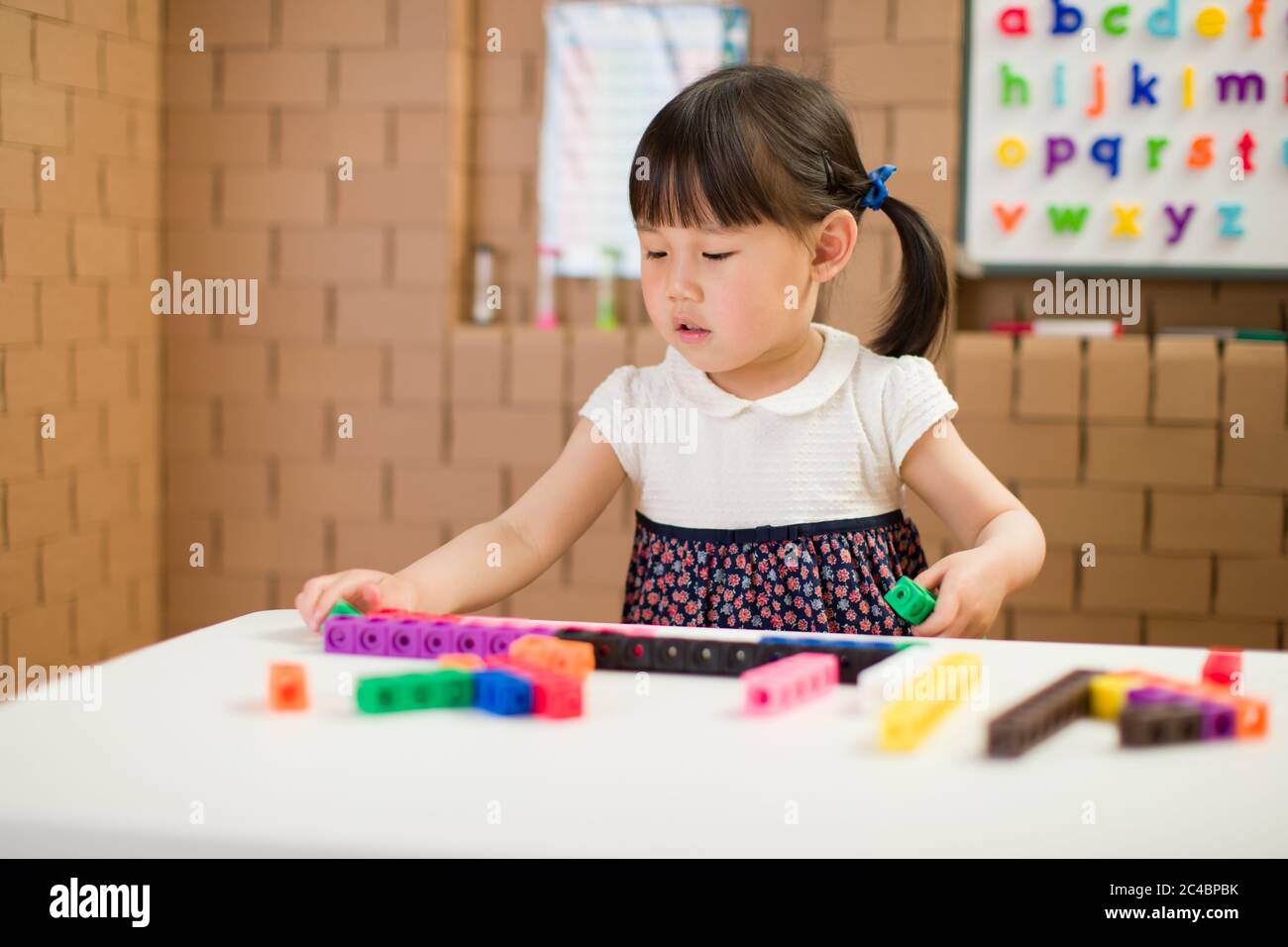 Girl numbers blocks happy hi-res stock photography and images - Alamy