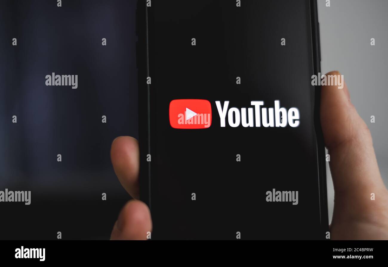 hands hold the iPhone with Youtube app logo on the screen Stock Photo ...