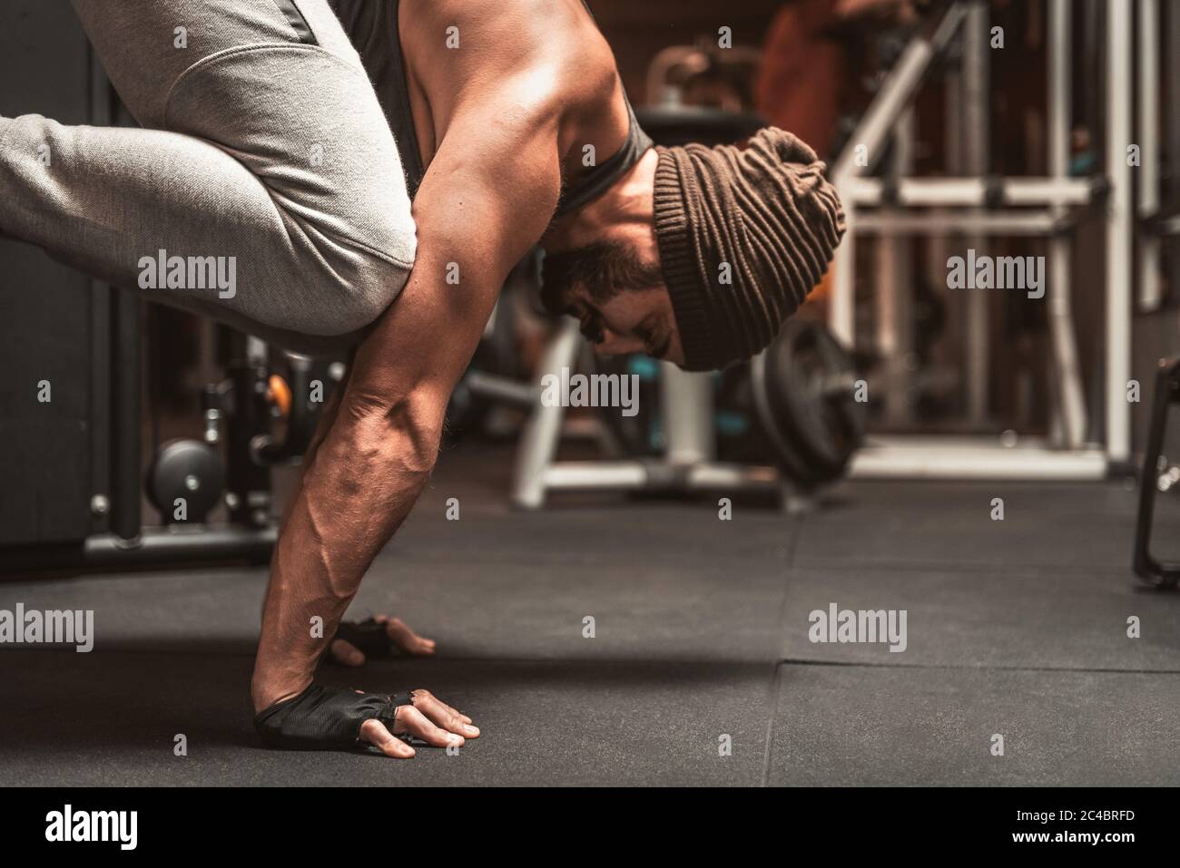 A bearded sporty man in the gym is doing Yoga exercises. Position on ...