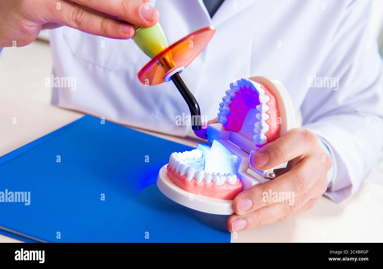The young dentist working in the dentistry hospital Stock Photo - Alamy