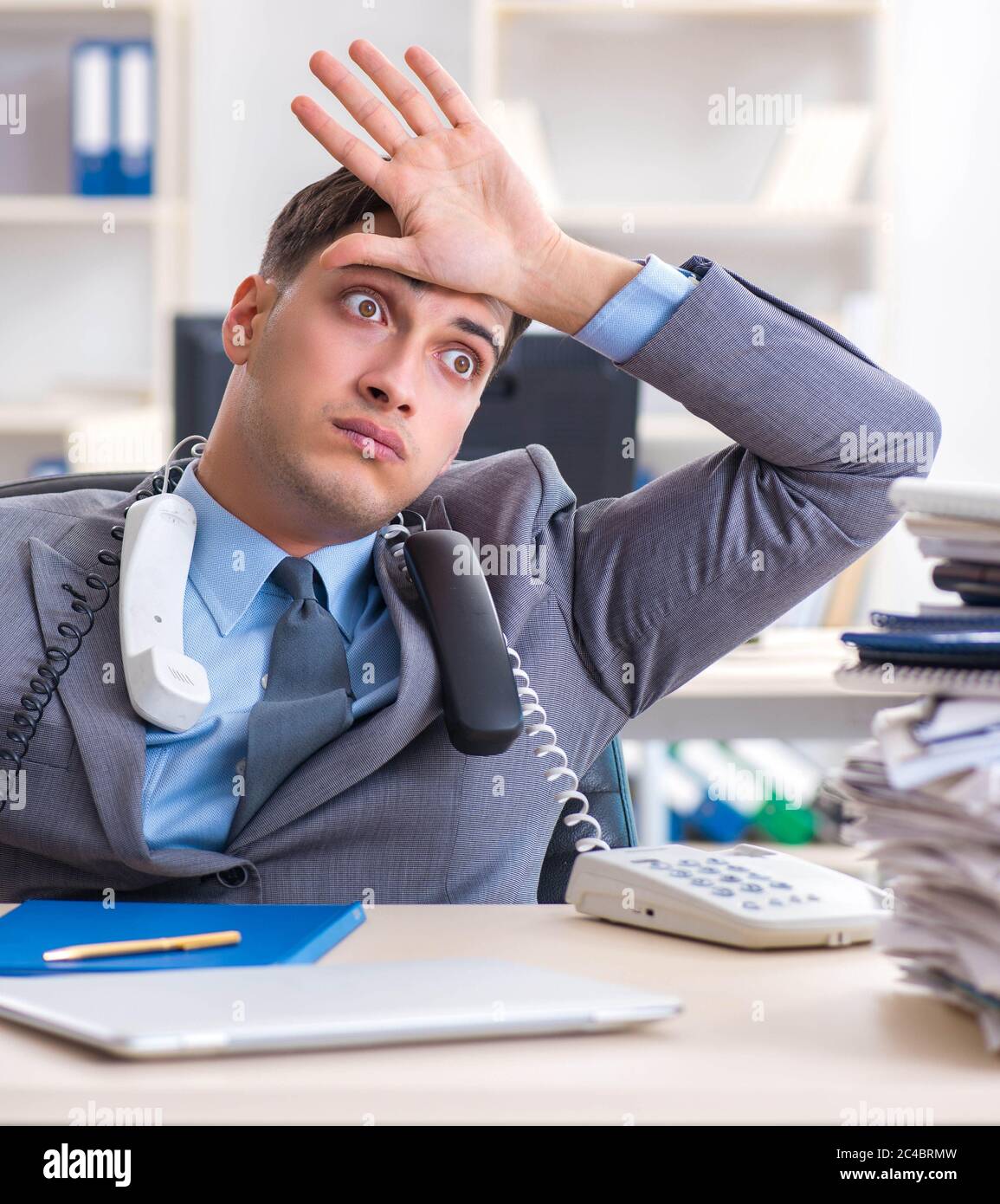 The desperate sad employee tired at his desk in call center Stock Photo ...
