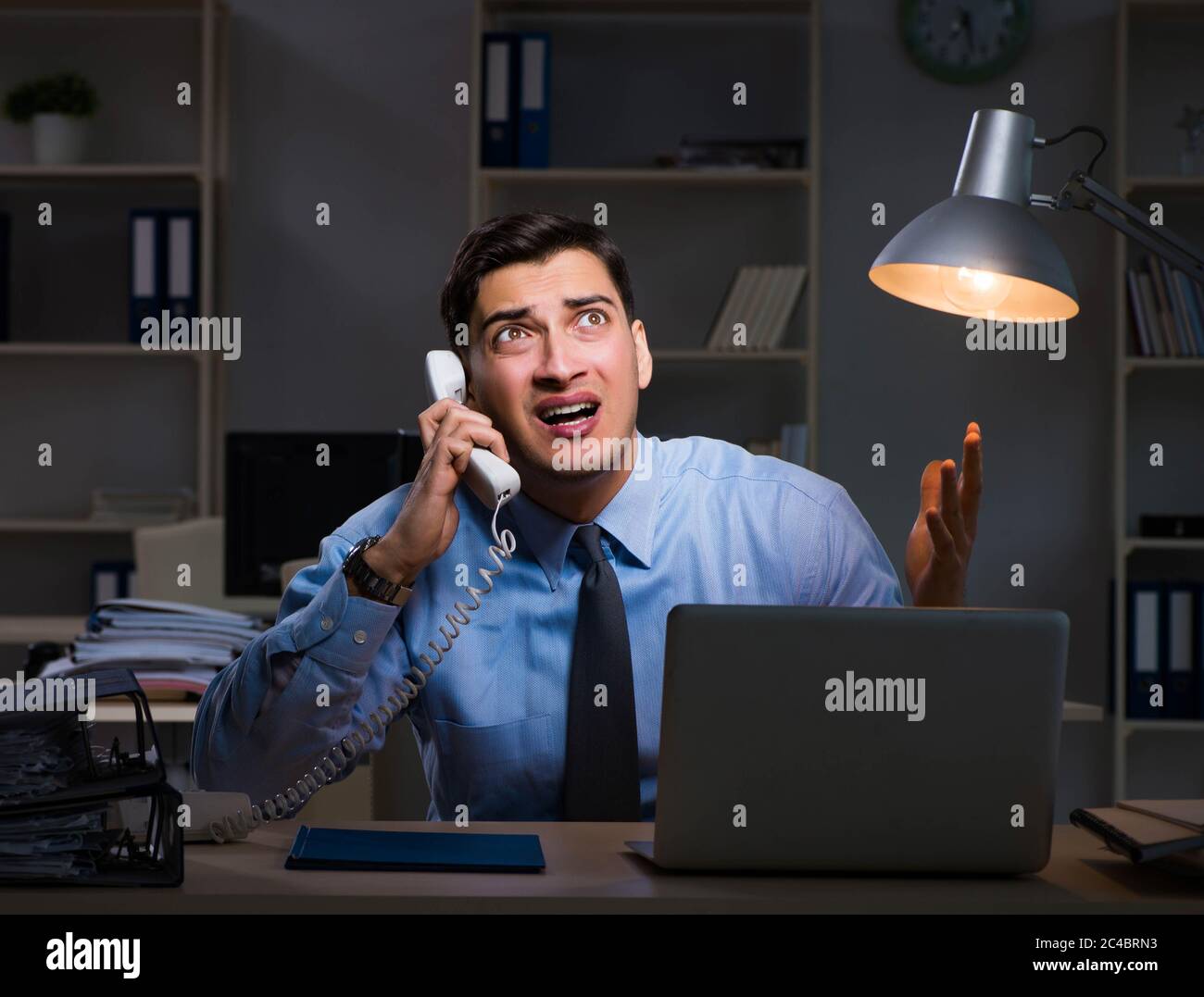 The employee working late at night at important report Stock Photo - Alamy