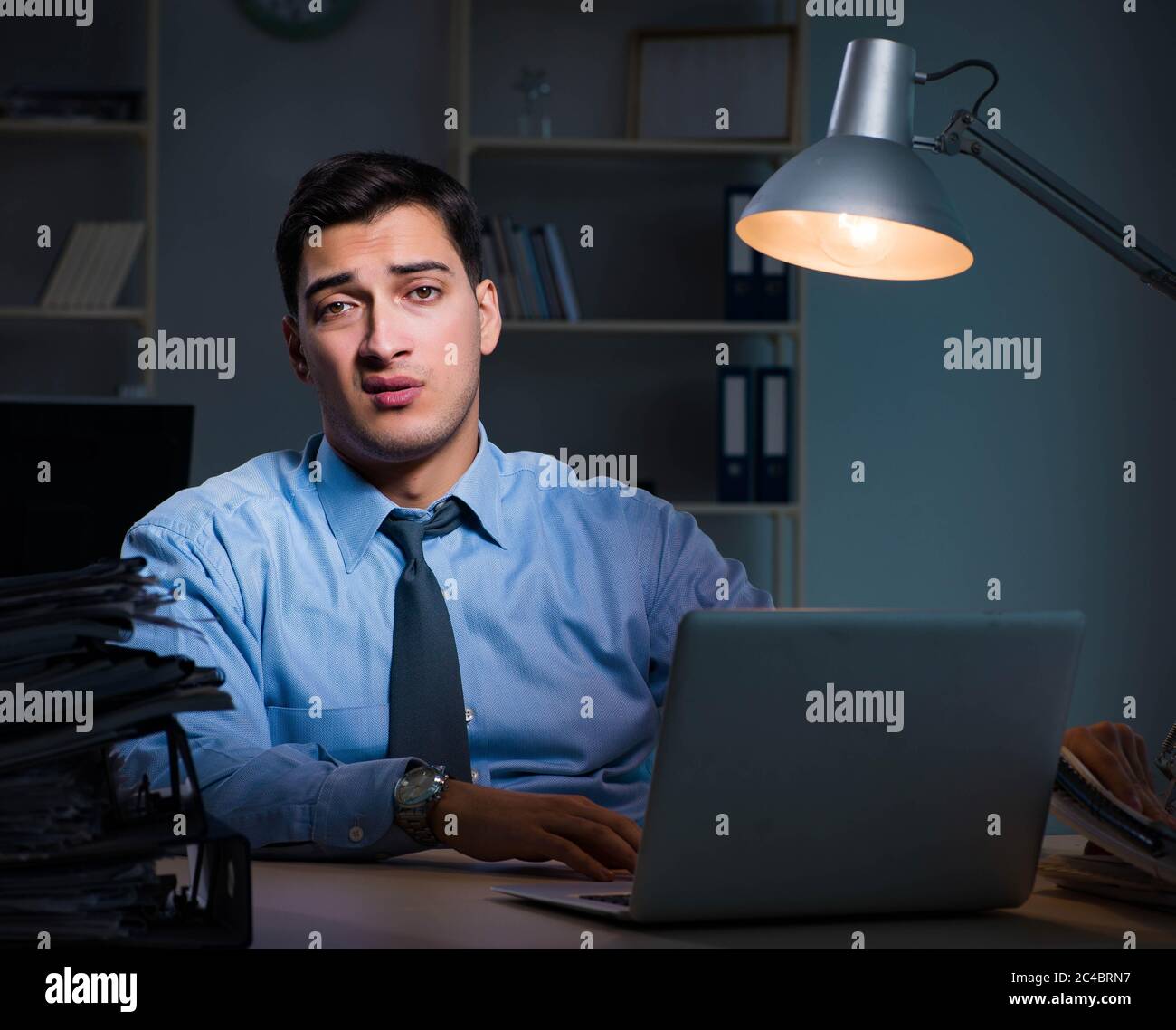 The employee working late at night at important report Stock Photo - Alamy