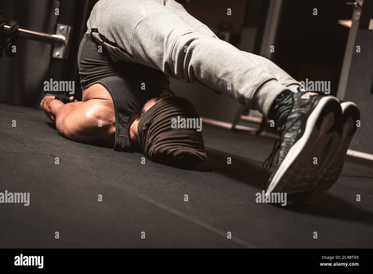 A sporty man in the gym is doing relaxation of yoga and martial arts ...