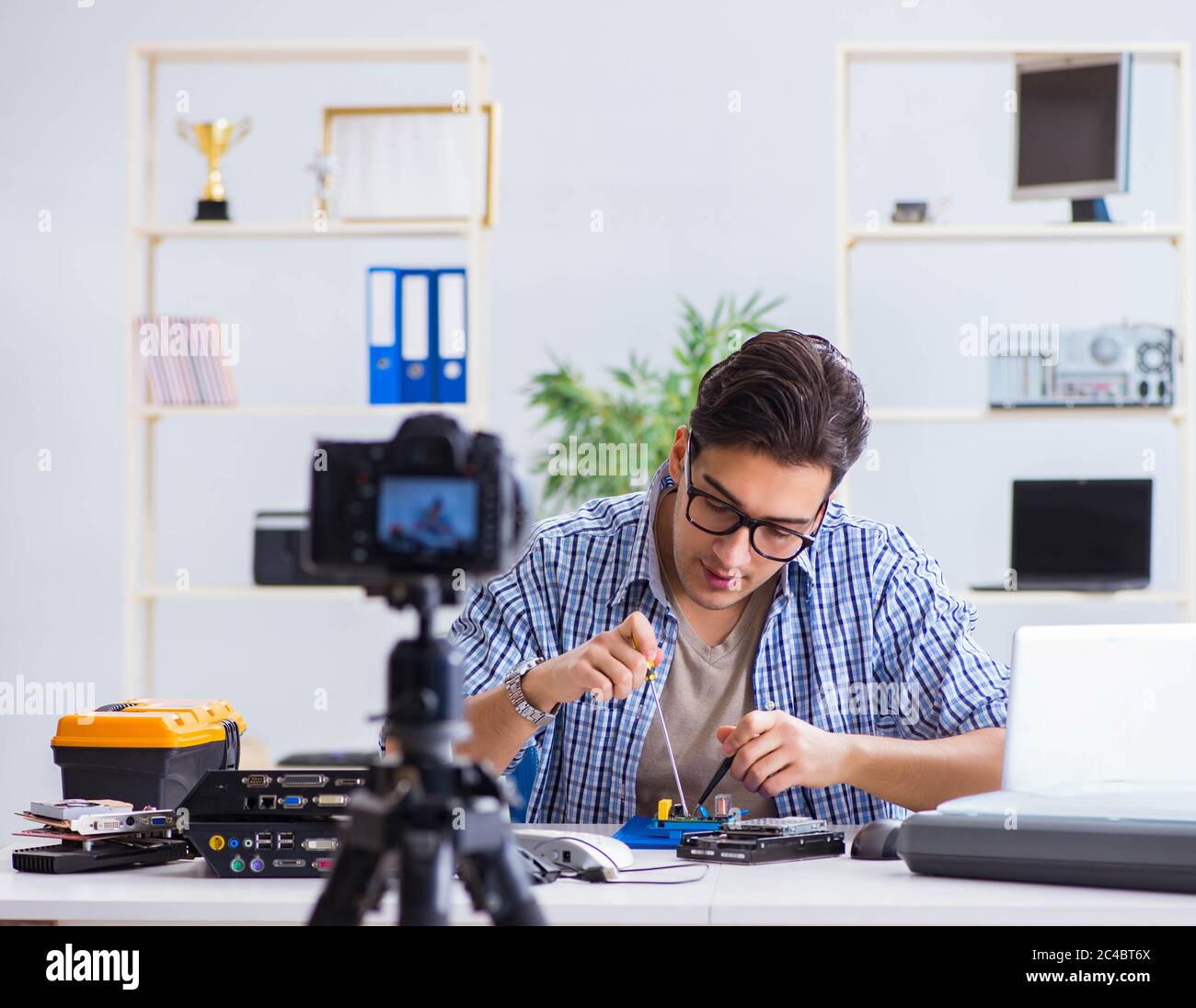 The vlogger recording computer repair on camera for vlog blog Stock ...