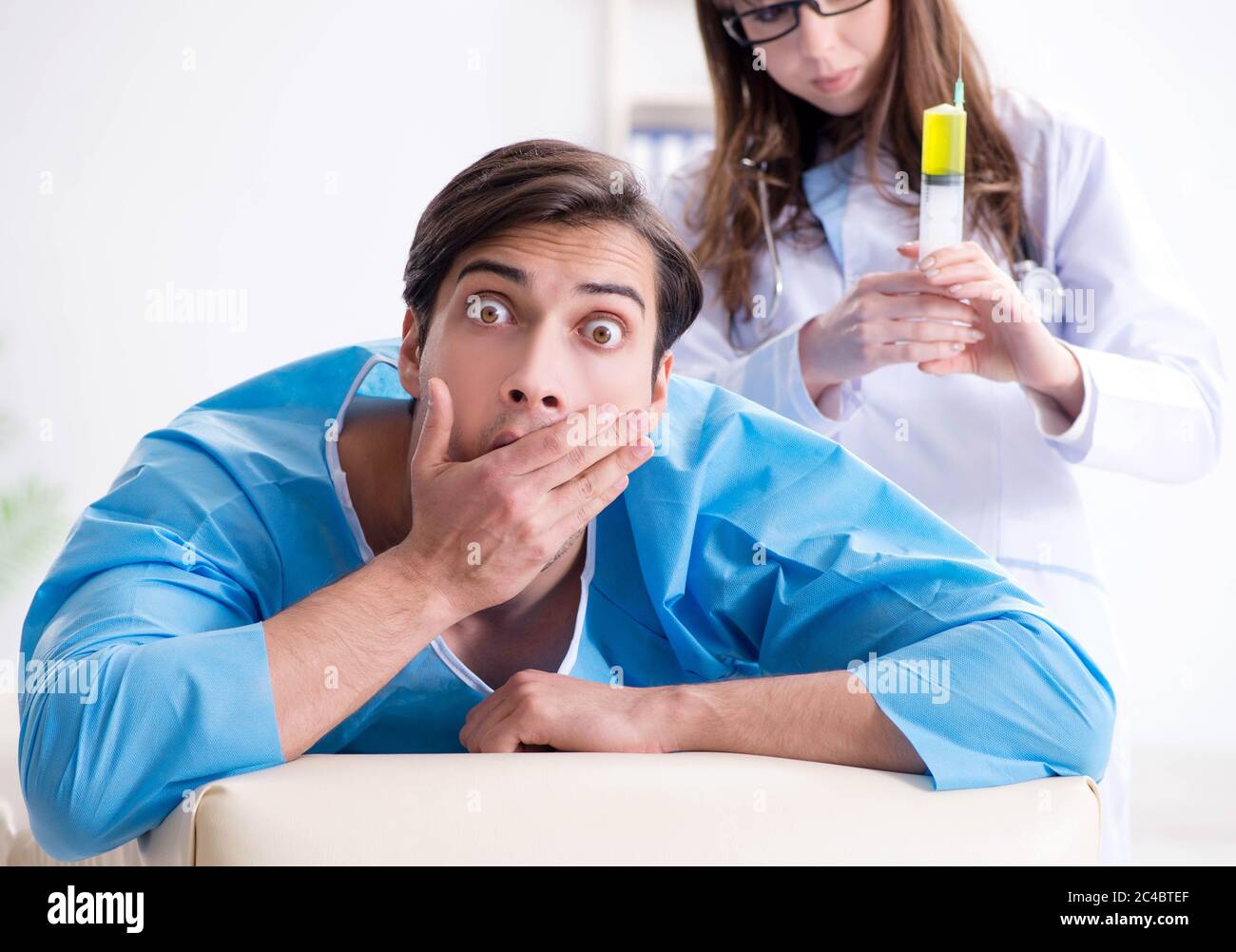 The funny man getting ready for buttocks syringe shot Stock Photo - Alamy