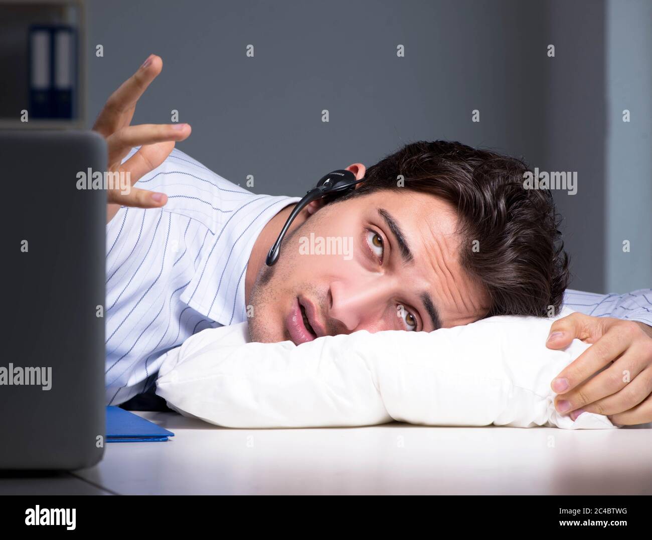 The tired and exhausted helpdesk operator during night shift Stock ...