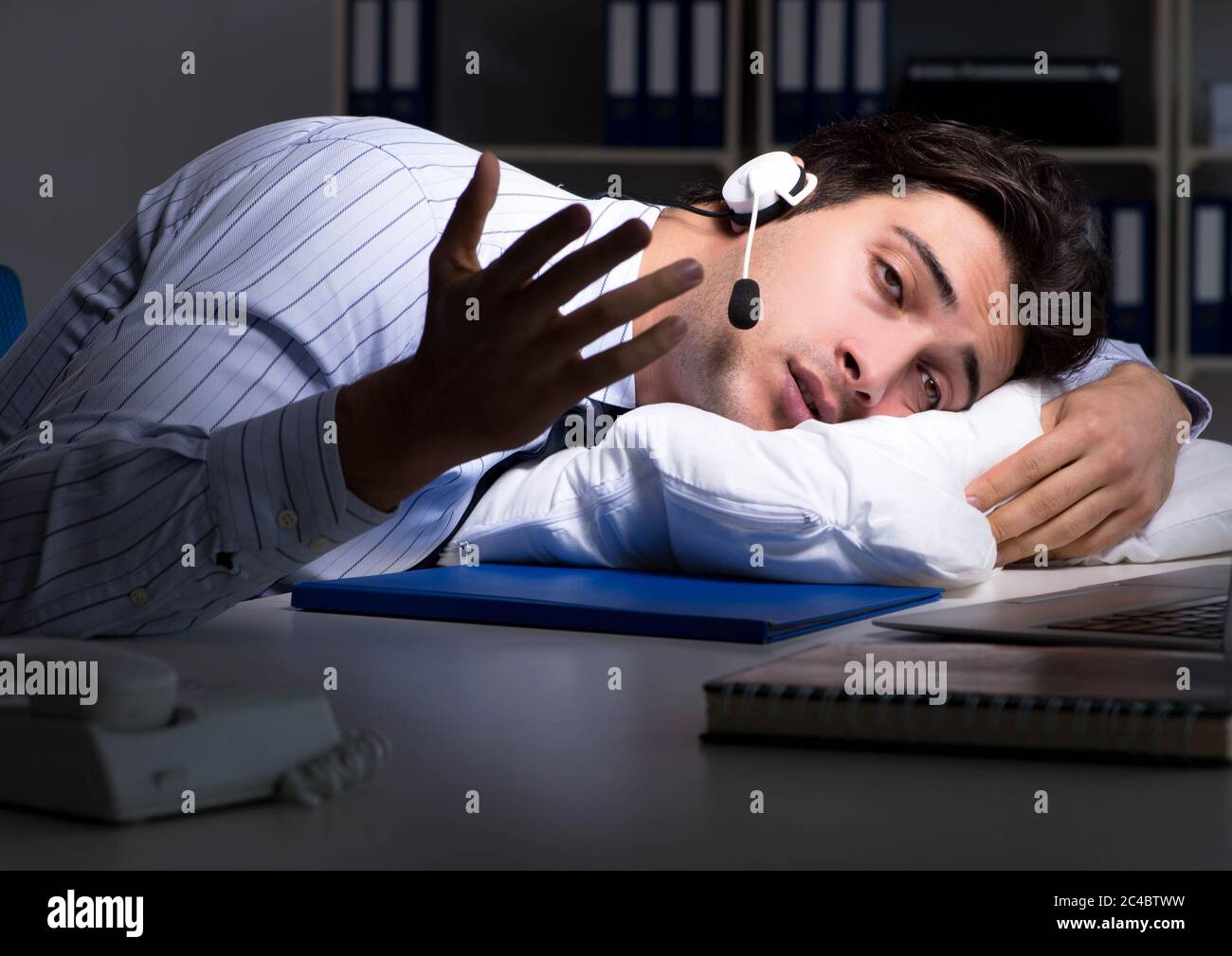 The tired and exhausted helpdesk operator during night shift Stock ...