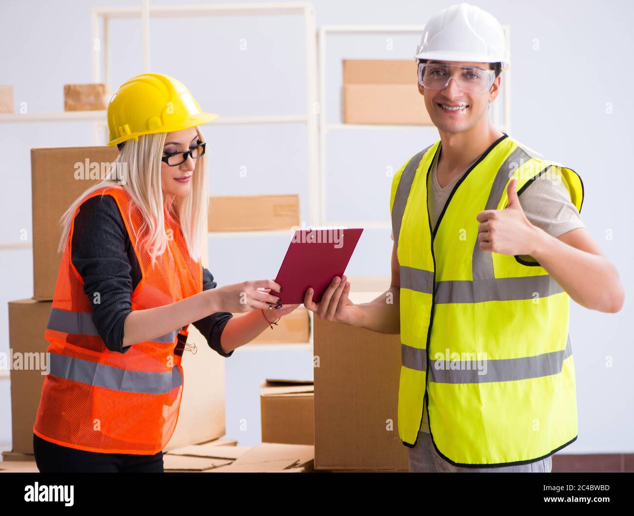 The delivery contractor delivering boxes to office Stock Photo - Alamy