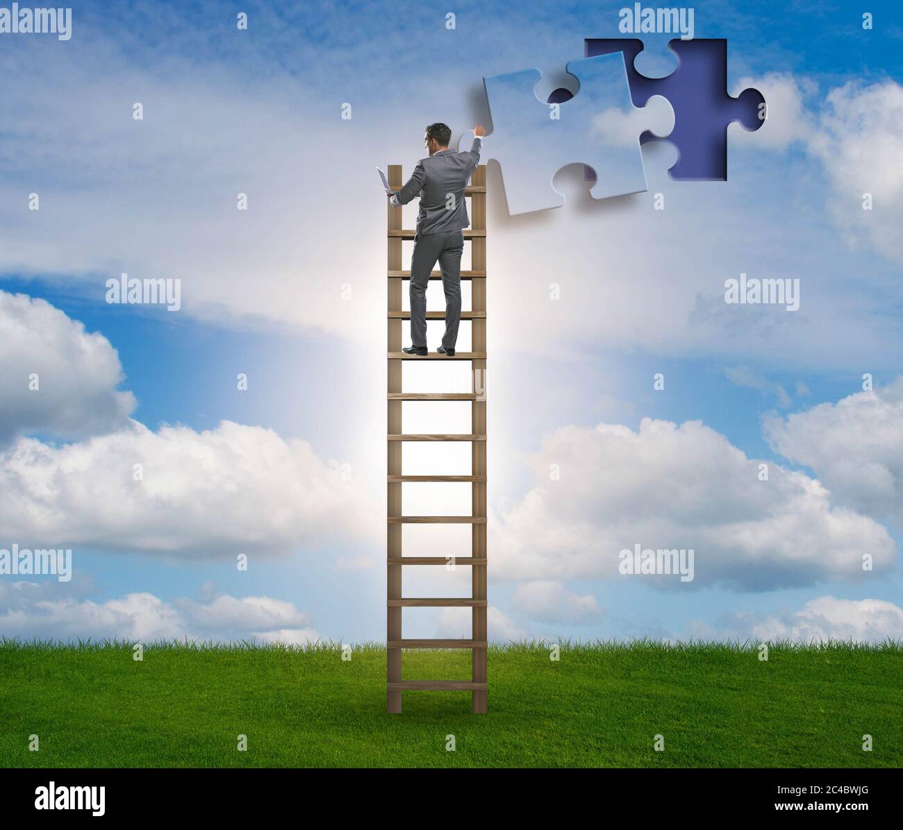 The businessman putting together jigsaw puzzle pieces Stock Photo - Alamy