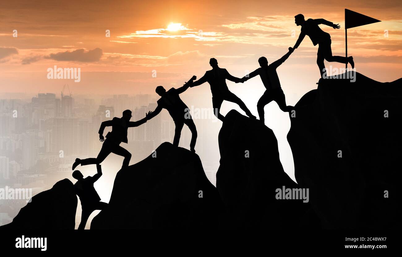 Concept of teamwork with the team climbing mountain top Stock Photo - Alamy