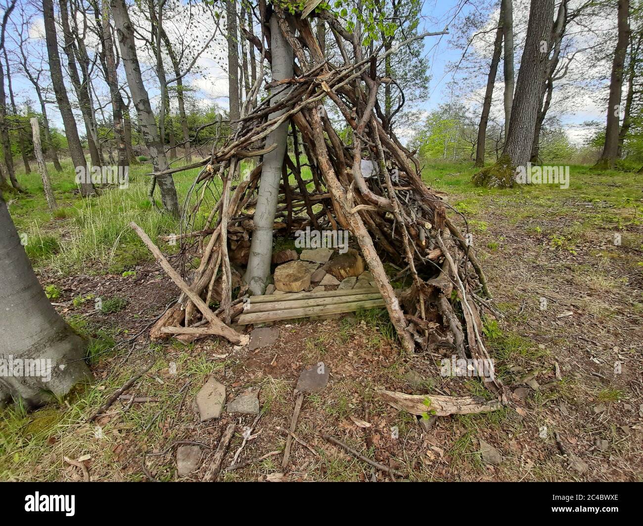 simple hut made of wood materials, children's playground in a forest ...