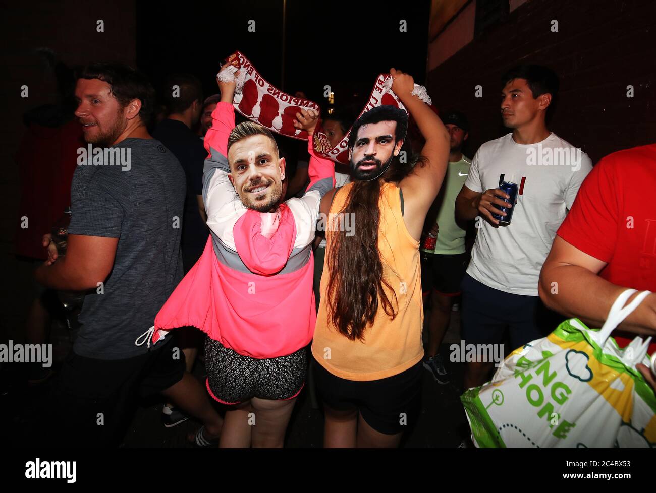 Liverpool fans wearing Jordan Henderson and Mohamed Salah face masks ...
