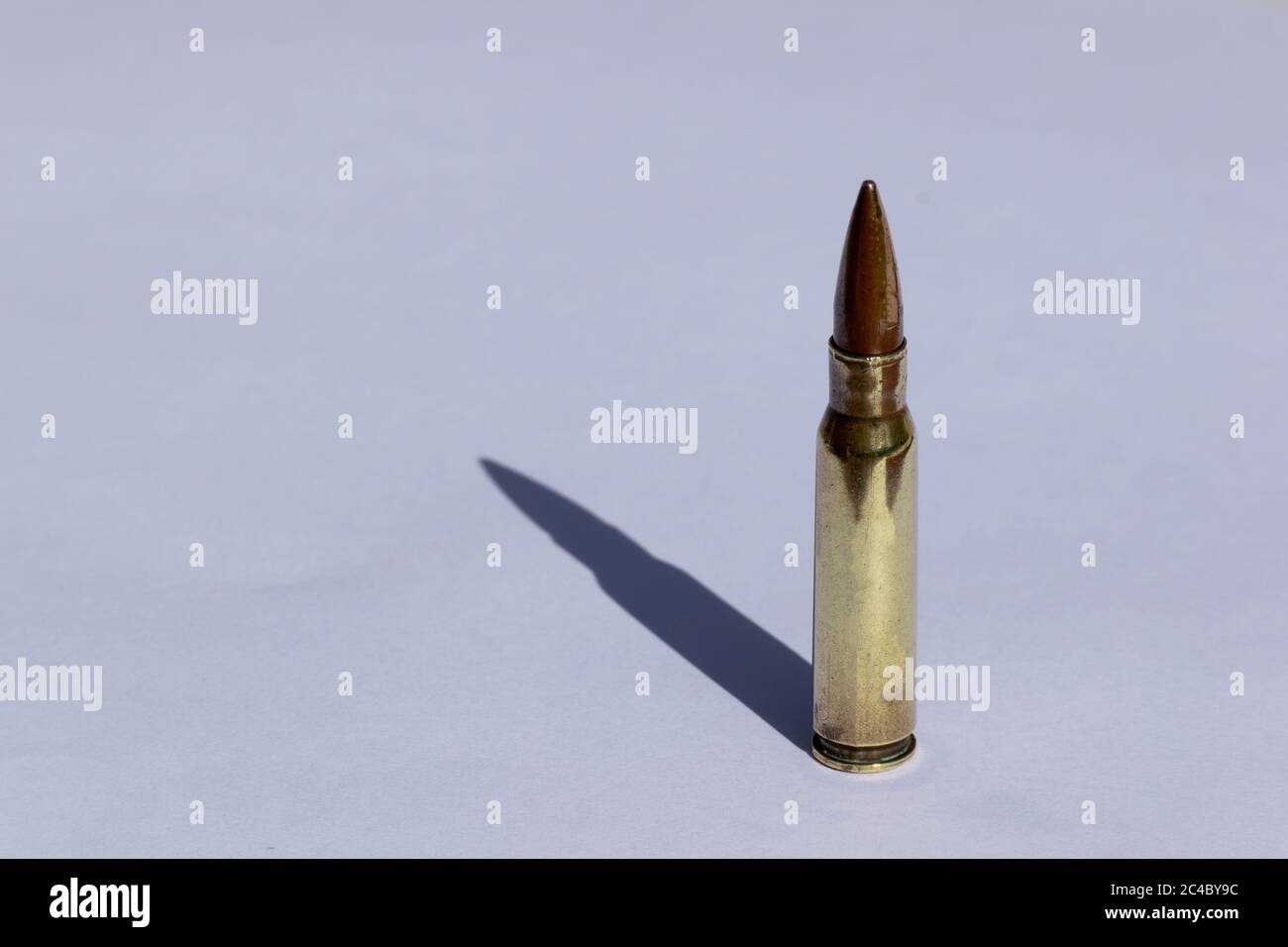 Metal rifle bullet with bronze and gold colors Stock Photo - Alamy