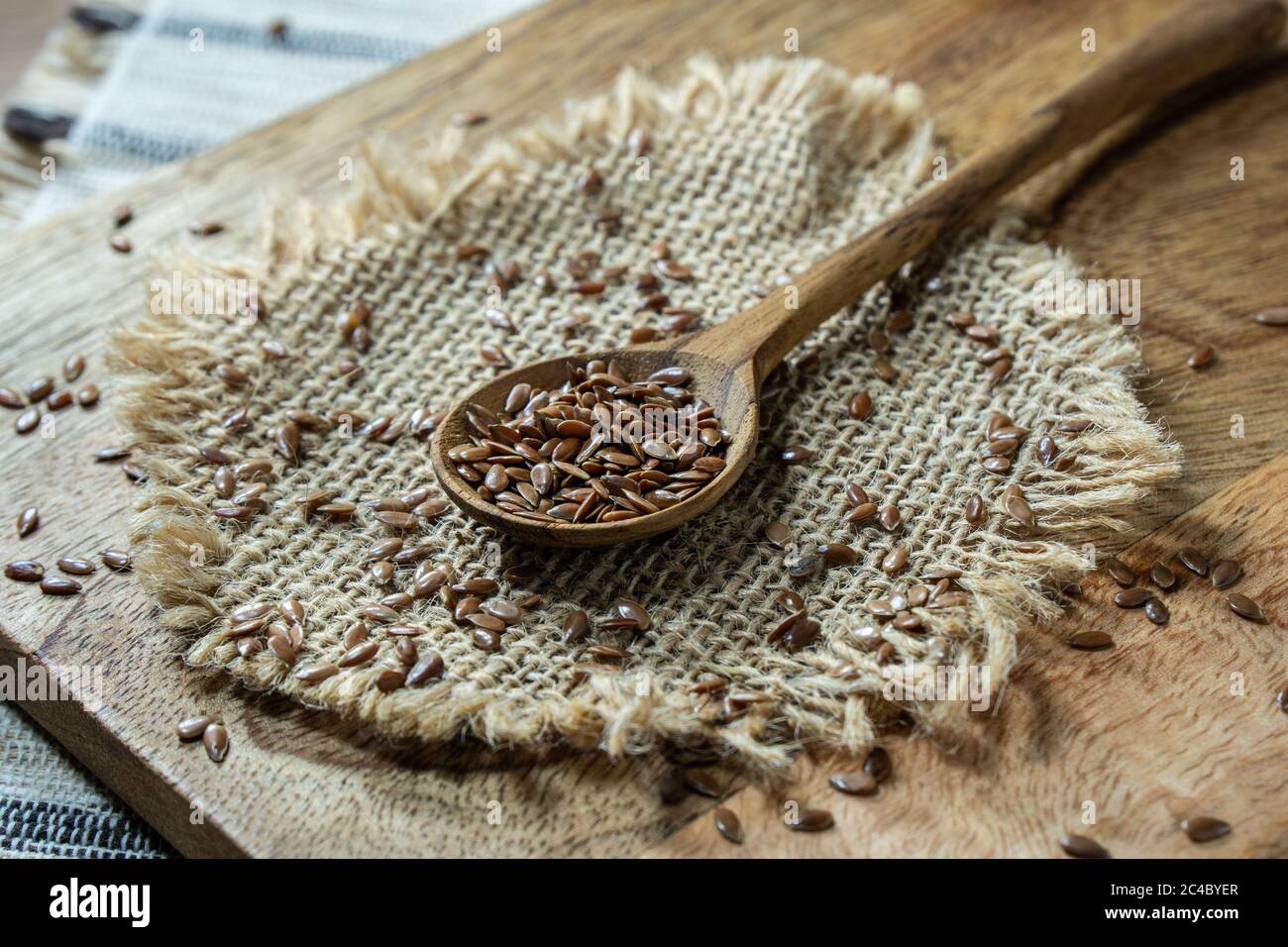 Flax seed inside wooden spoon on rustic table. Flaxseed is an organic and healthy grain packed ...