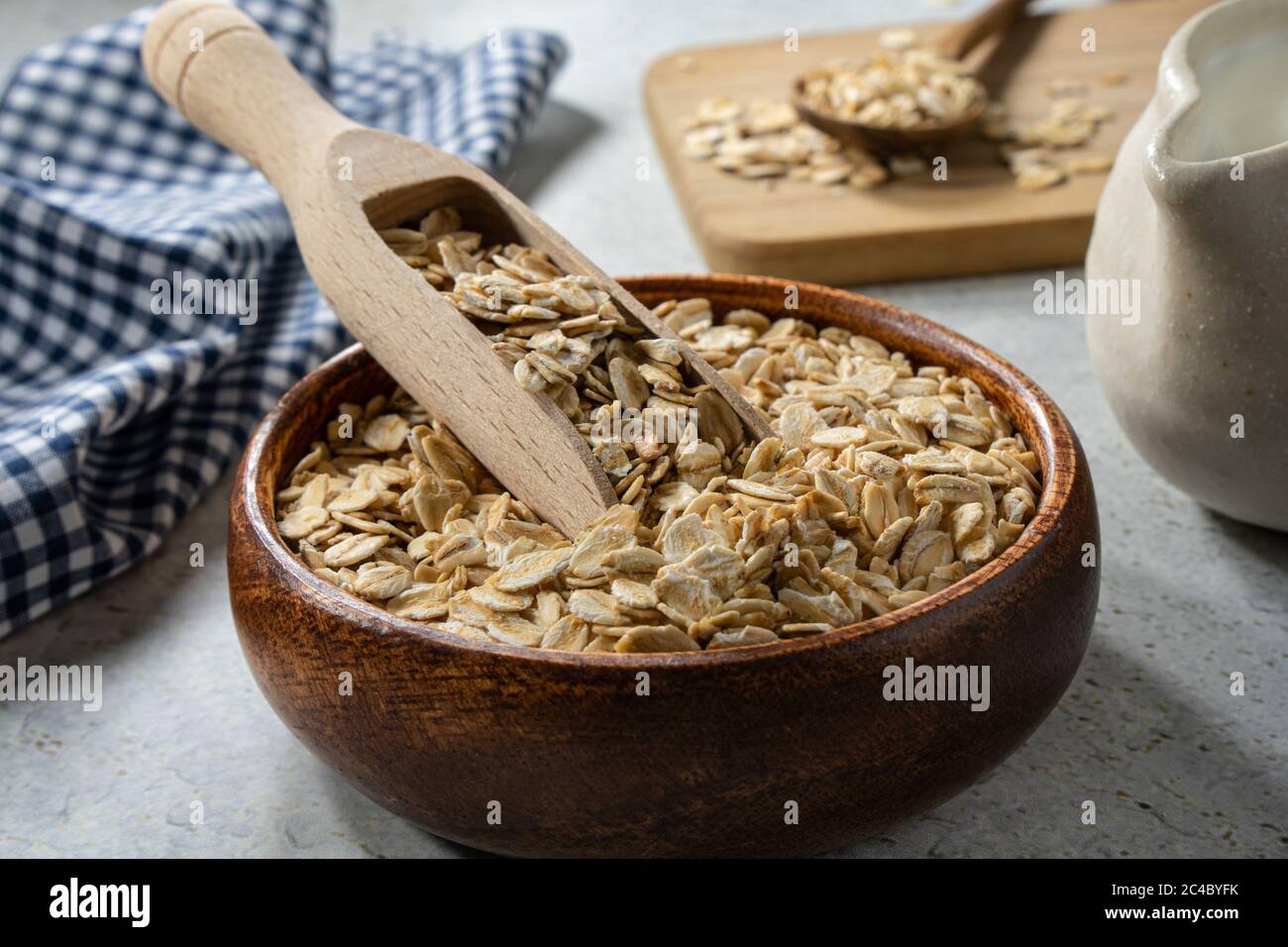 Breakfast oats inside rustic bowl with wooden scoop. Oats are a natural ...
