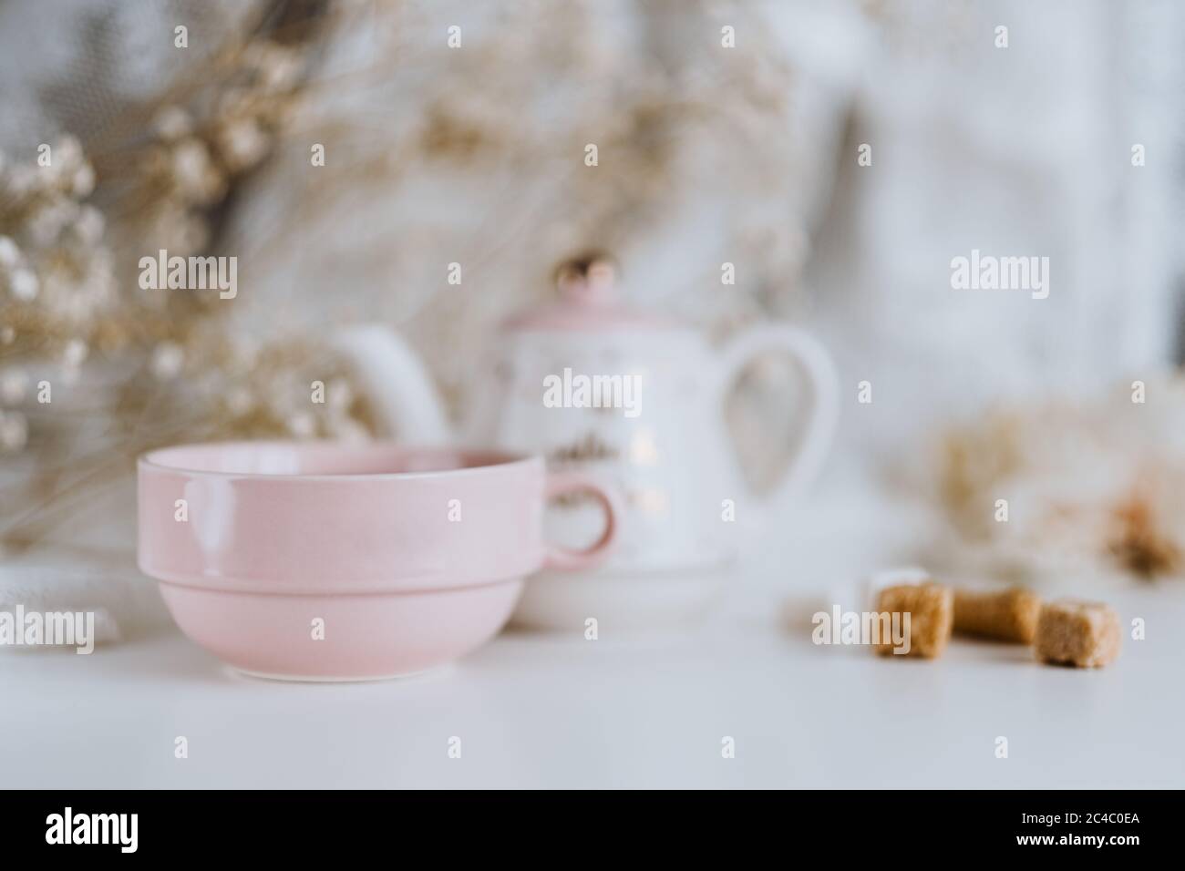 Tea set, teapot with sugar cubes and a cup with brewed tea Stock Photo ...