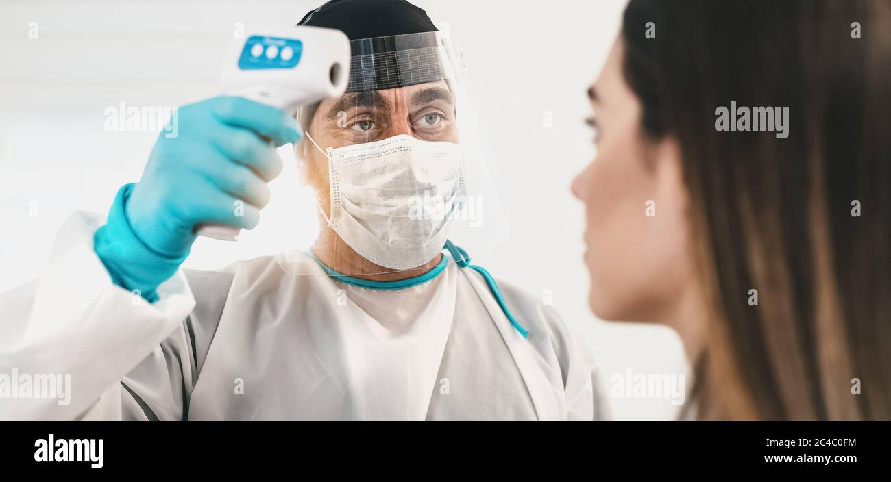 Doctor measuring temperature with new digital thermometer to young ...