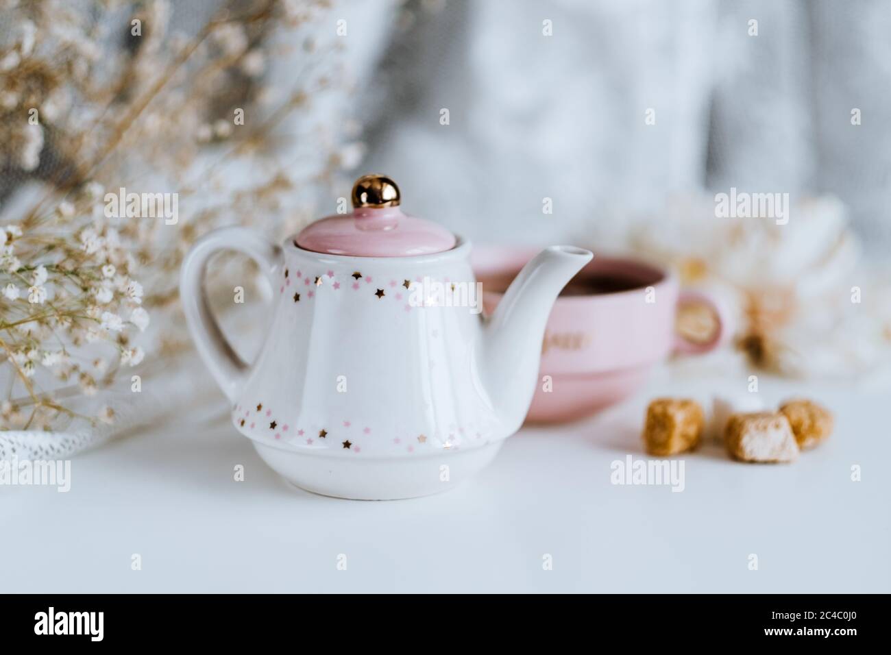 Tea set, teapot with sugar cubes and a cup with brewed tea Stock Photo ...