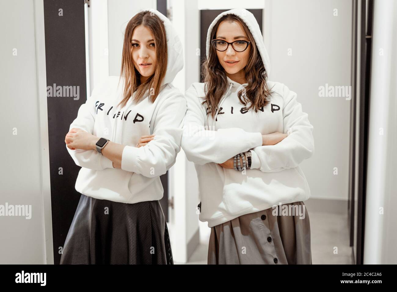 Shopping, fitting clothes. Two girls in a fitting room in identical ...