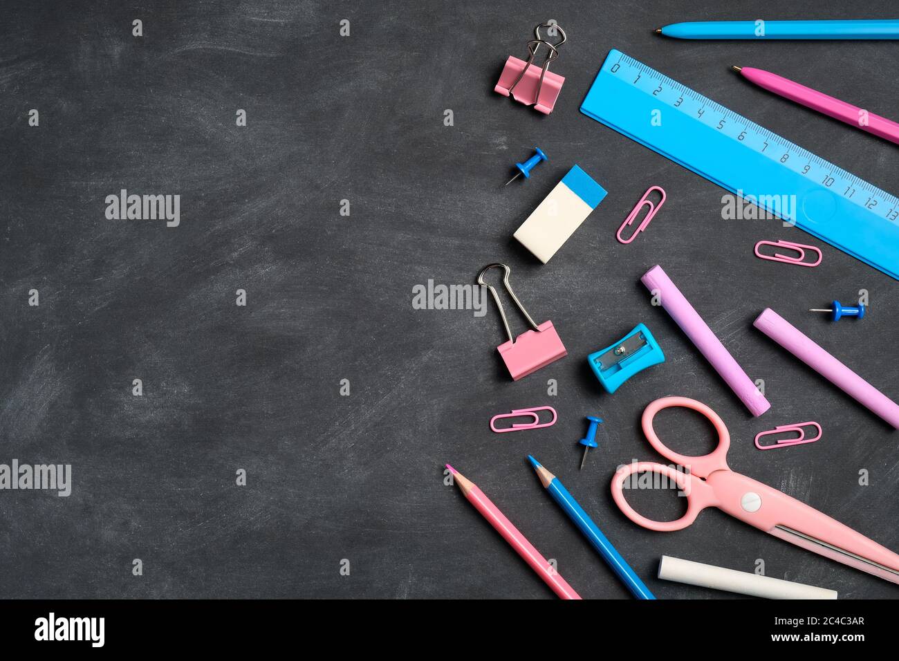 Back to school concept. Modern blue and pink school supplies on black ...