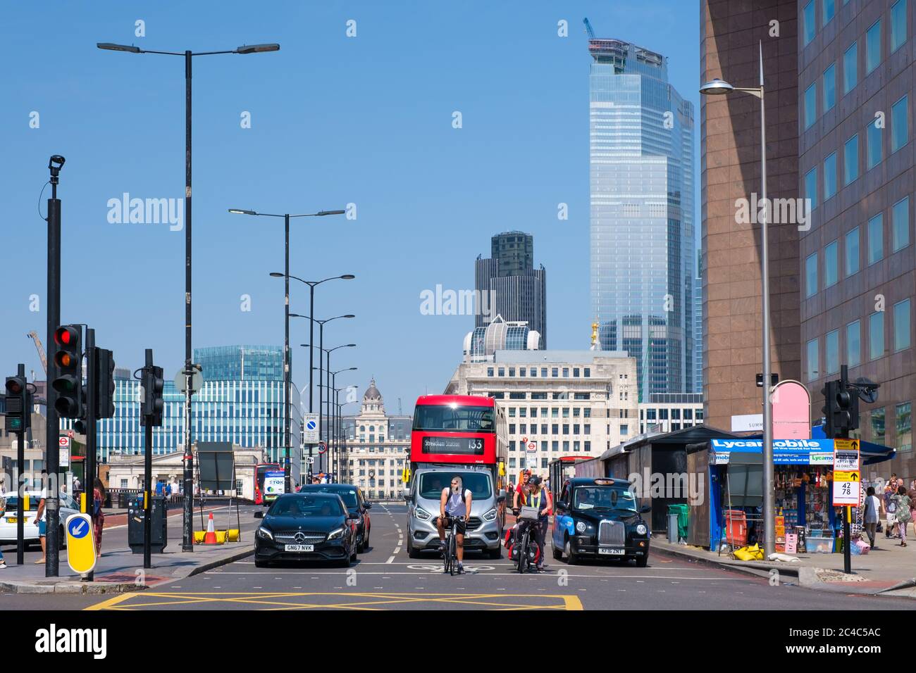 Traffic on the London Bridge with a view of the City of London on a ...