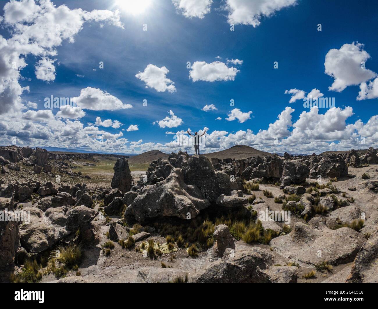 Young man sitting on the rocks hi-res stock photography and images - Alamy