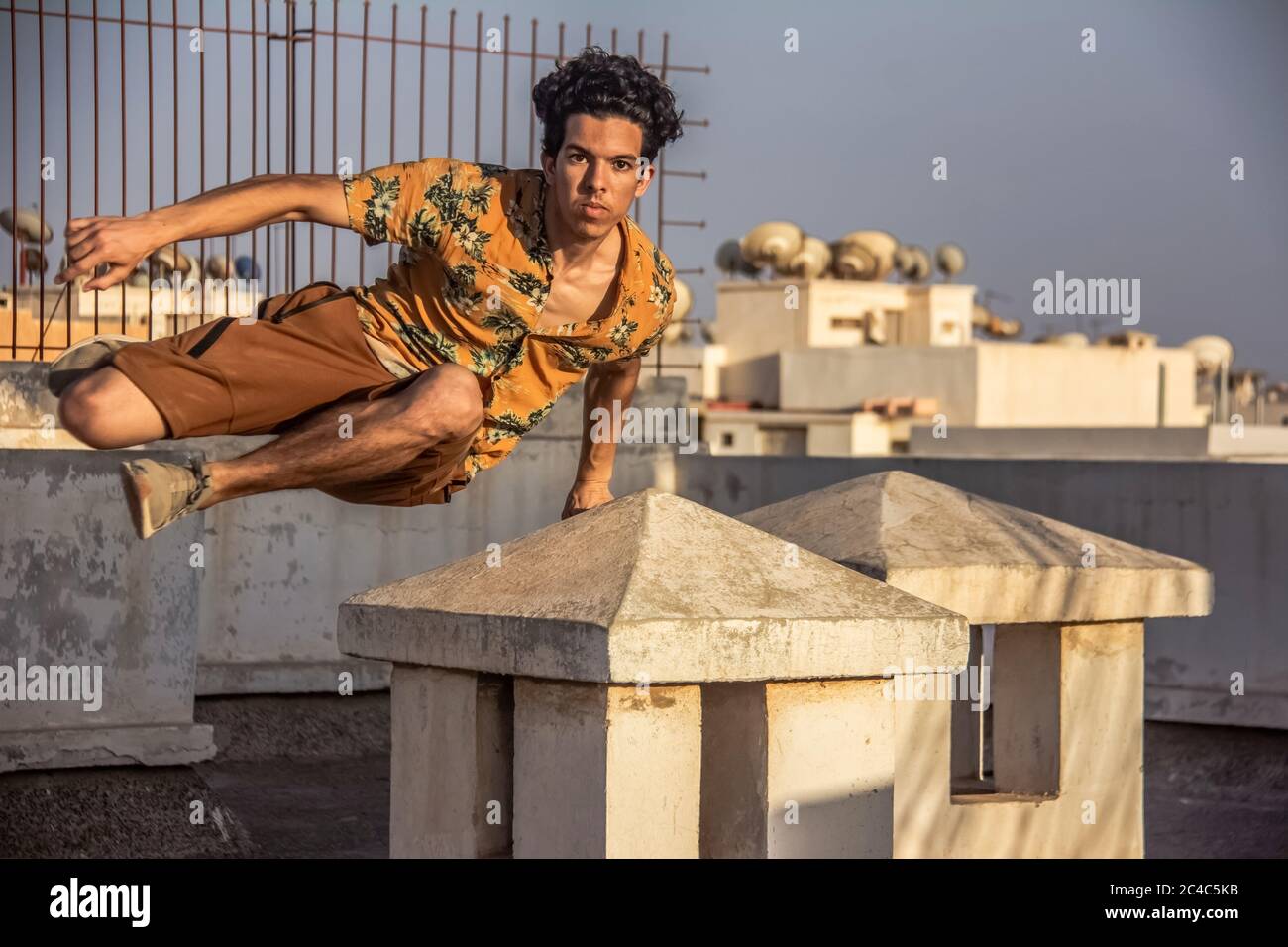 Moroccan parkour athlete playing parkour on the rooftop Stock Photo - Alamy